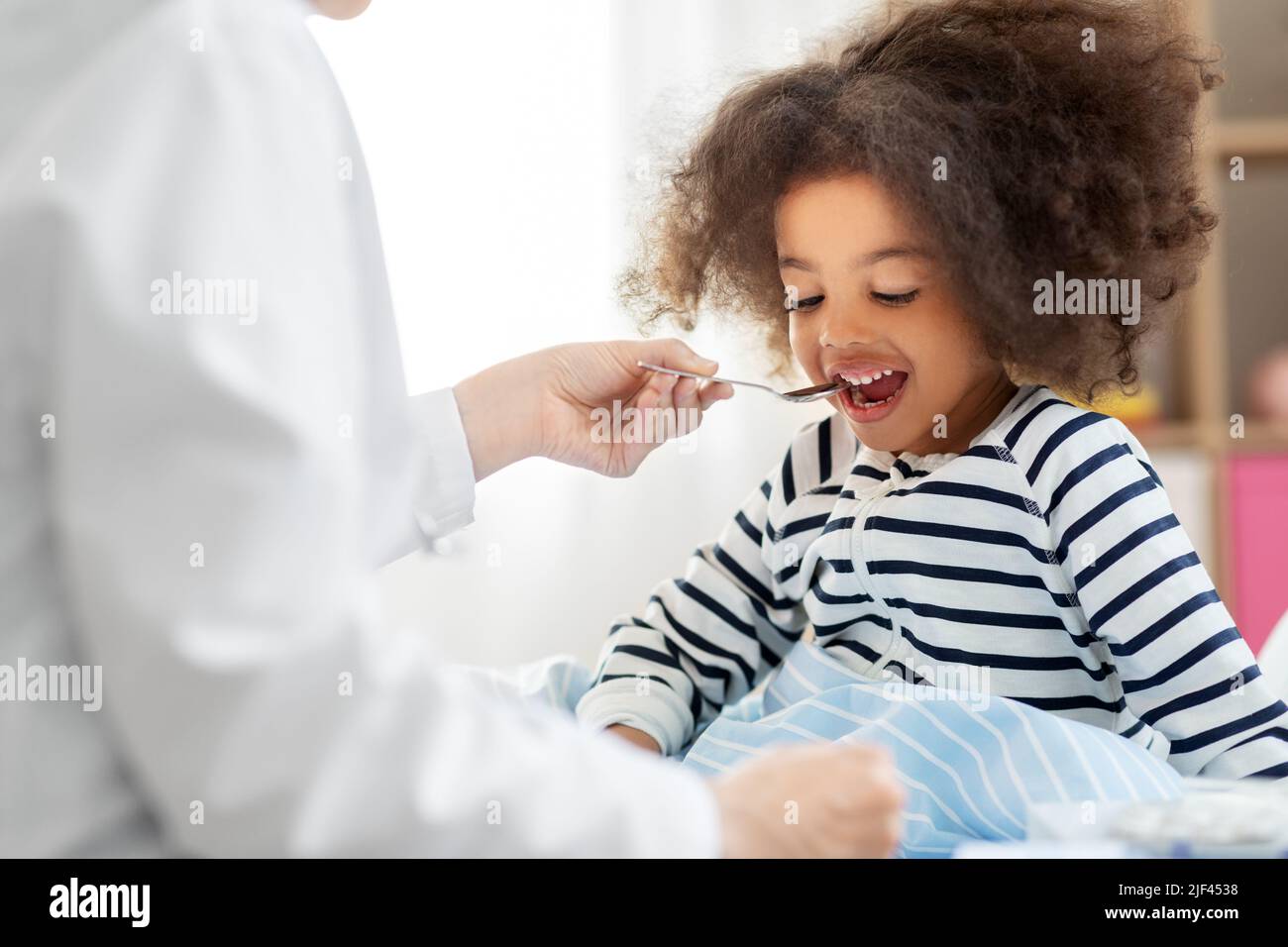 doctor giving medicine to sick girl in bed at home Stock Photo - Alamy