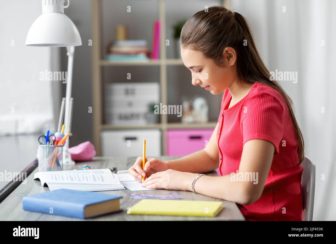 student girl with ruler drawing line in notebook Stock Photo - Alamy