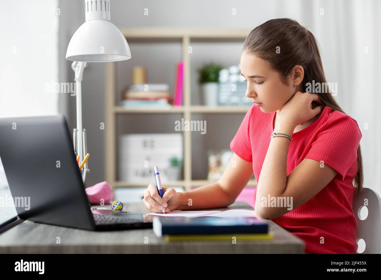 teenage student girl writing to notebook at home Stock Photo - Alamy