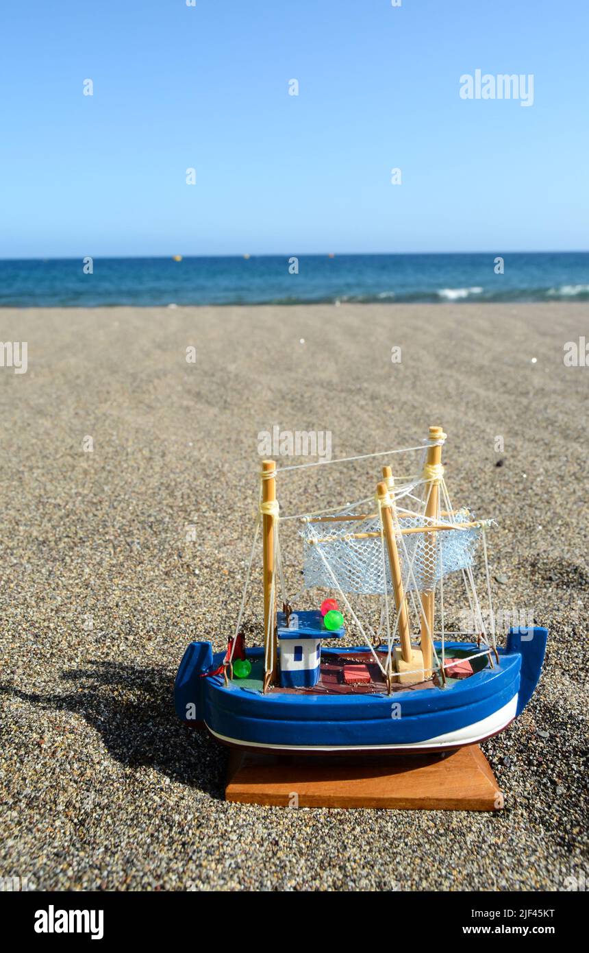 Sail Ship Toy Model in the Beach Sand Close-up Stock Photo - Alamy