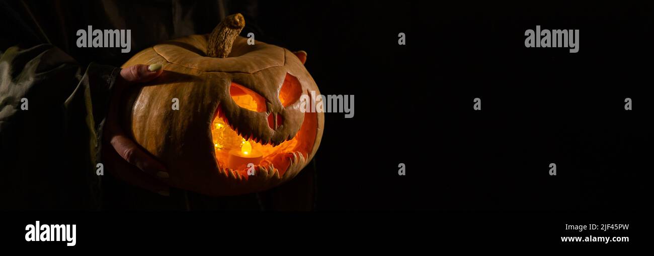 The witch is holding a pumpkin jack o lantern glowing in the dark ...