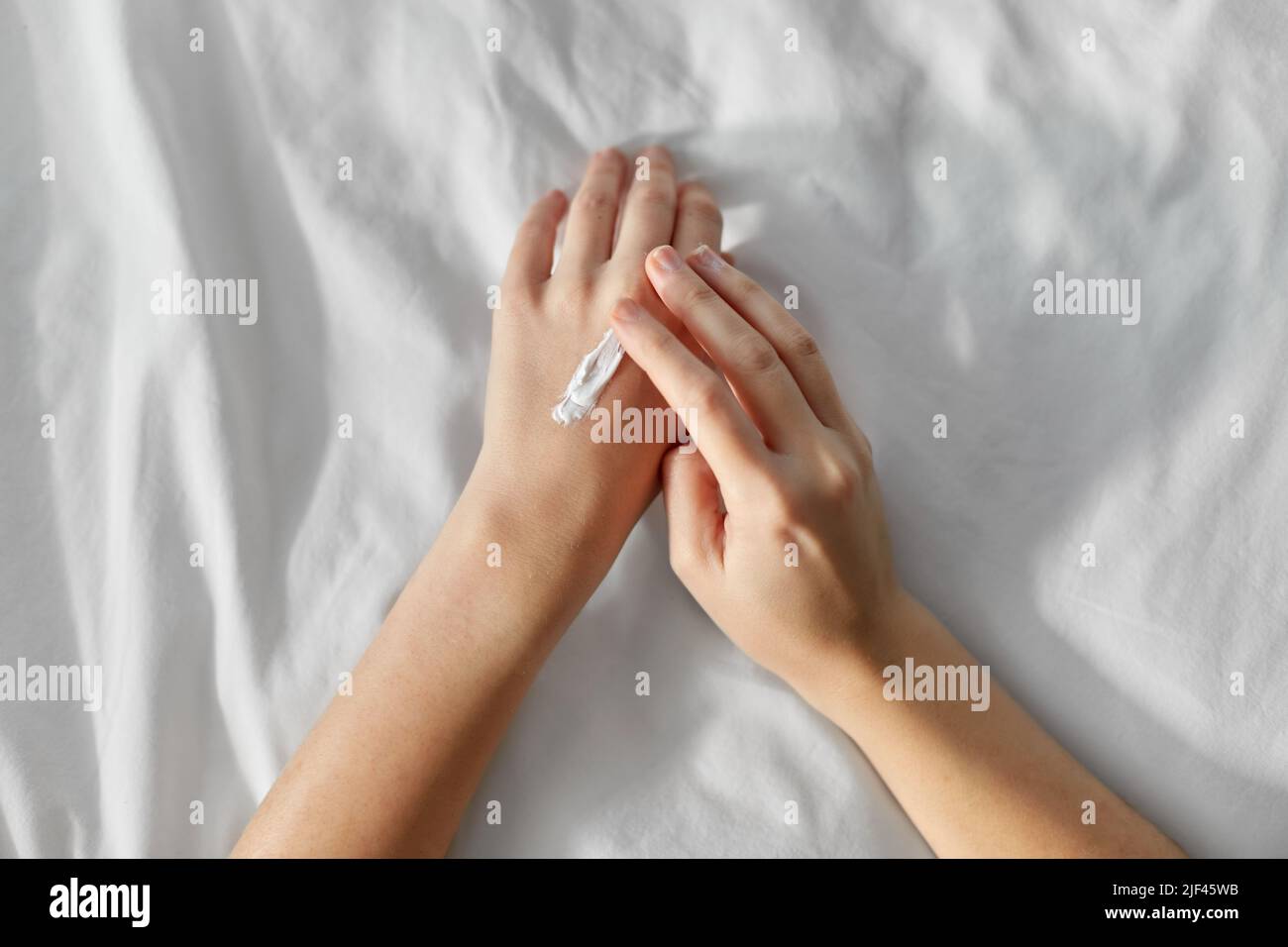 woman applying hand cream at home Stock Photo - Alamy