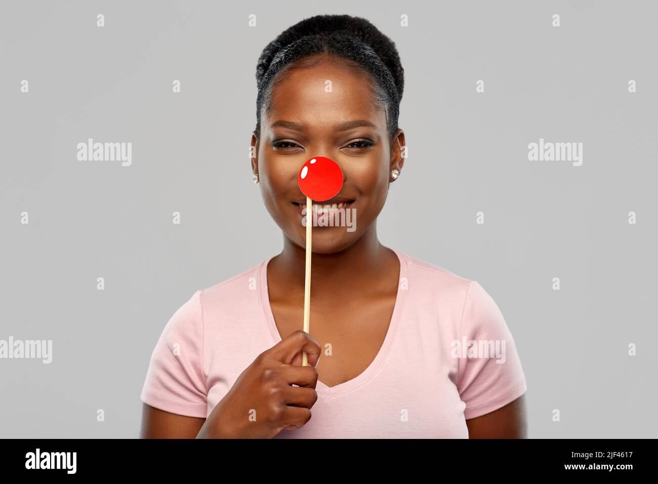 happy african american woman with red clown nose Stock Photo - Alamy