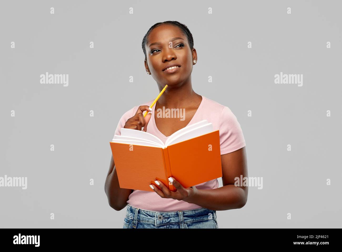 Thoughtful woman pencil notebook hi-res stock photography and images ...