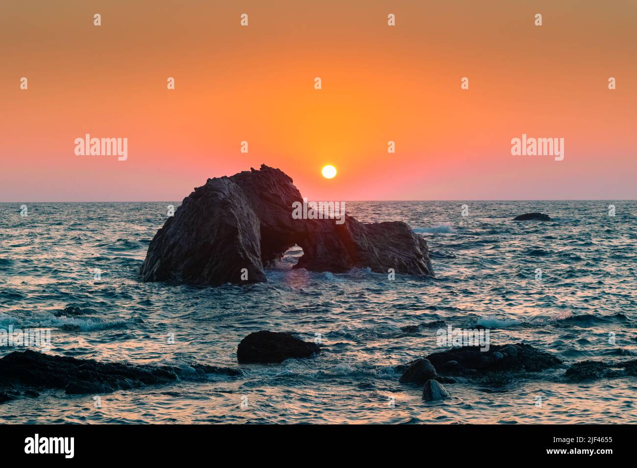Sunset over rock formation in Sfinari beach, Crete, Greece Stock Photo ...