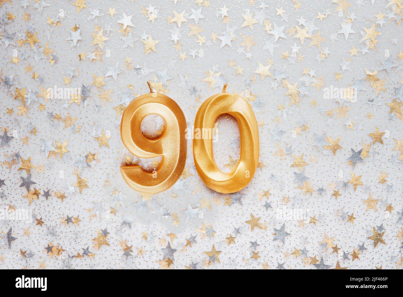 Number 90 ninety golden celebration birthday candle on Festive ...
