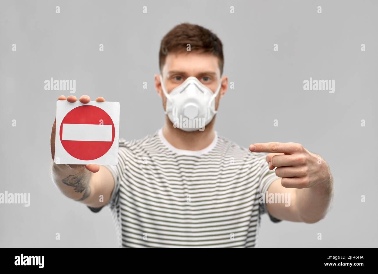 man in respirator mask showing stop sign Stock Photo - Alamy