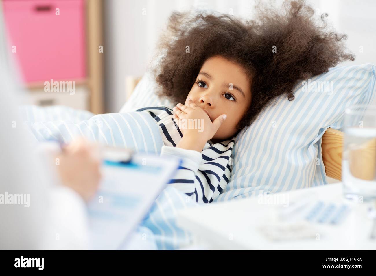 doctor with clipboard and sick girl in bed at home Stock Photo - Alamy