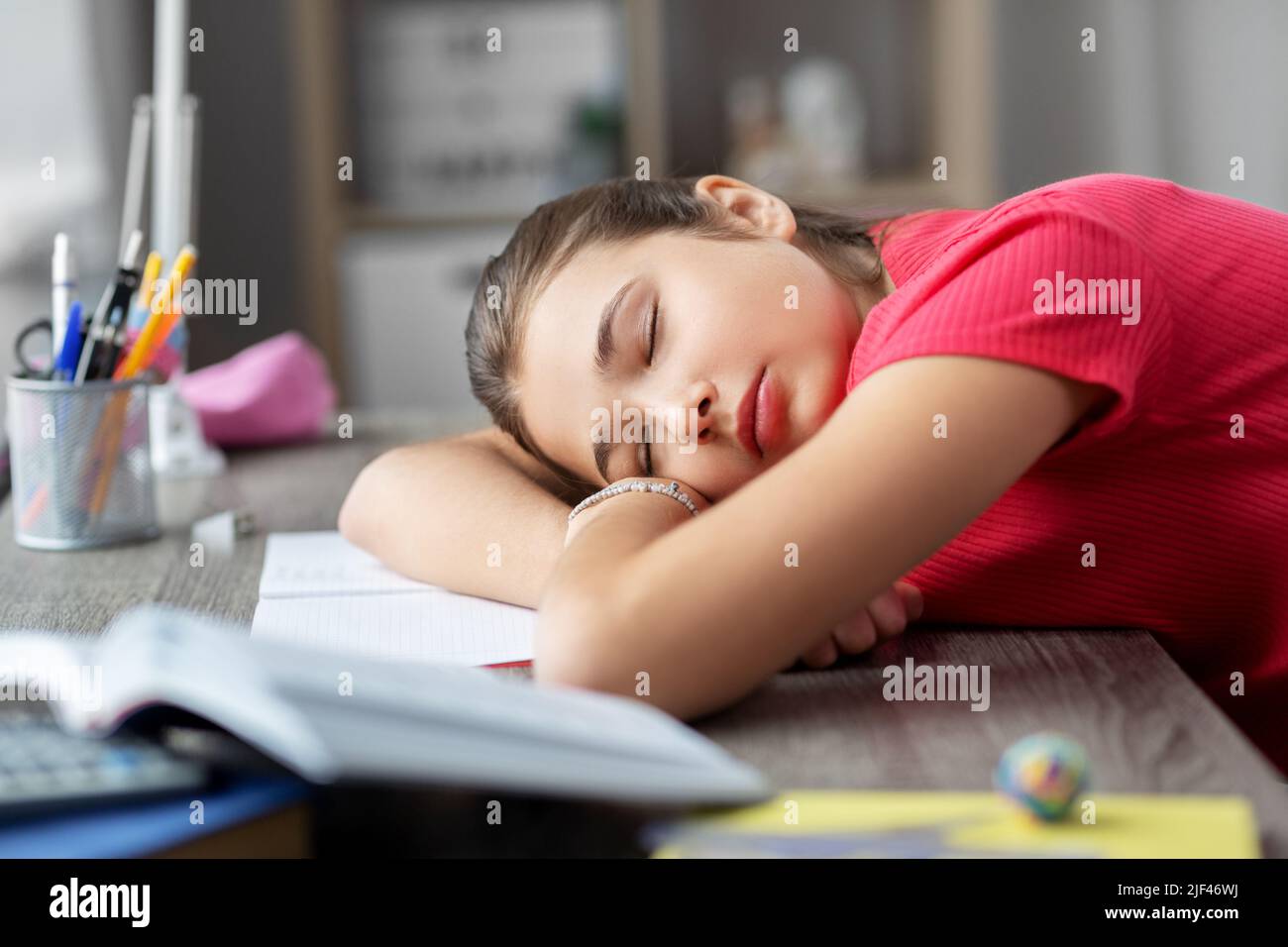 tired student girl sleeping on table at home Stock Photo - Alamy
