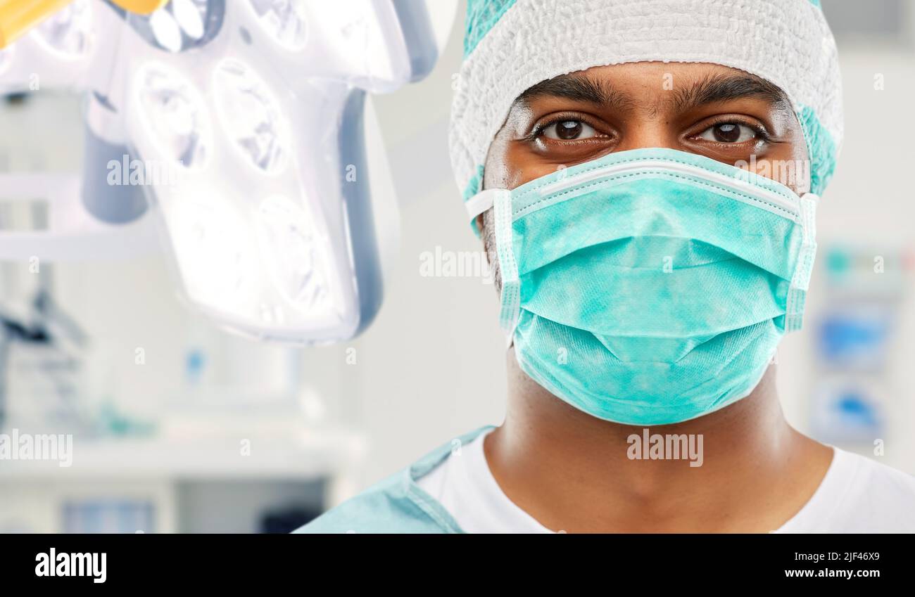 indian male surgeon in mask over operating room Stock Photo - Alamy