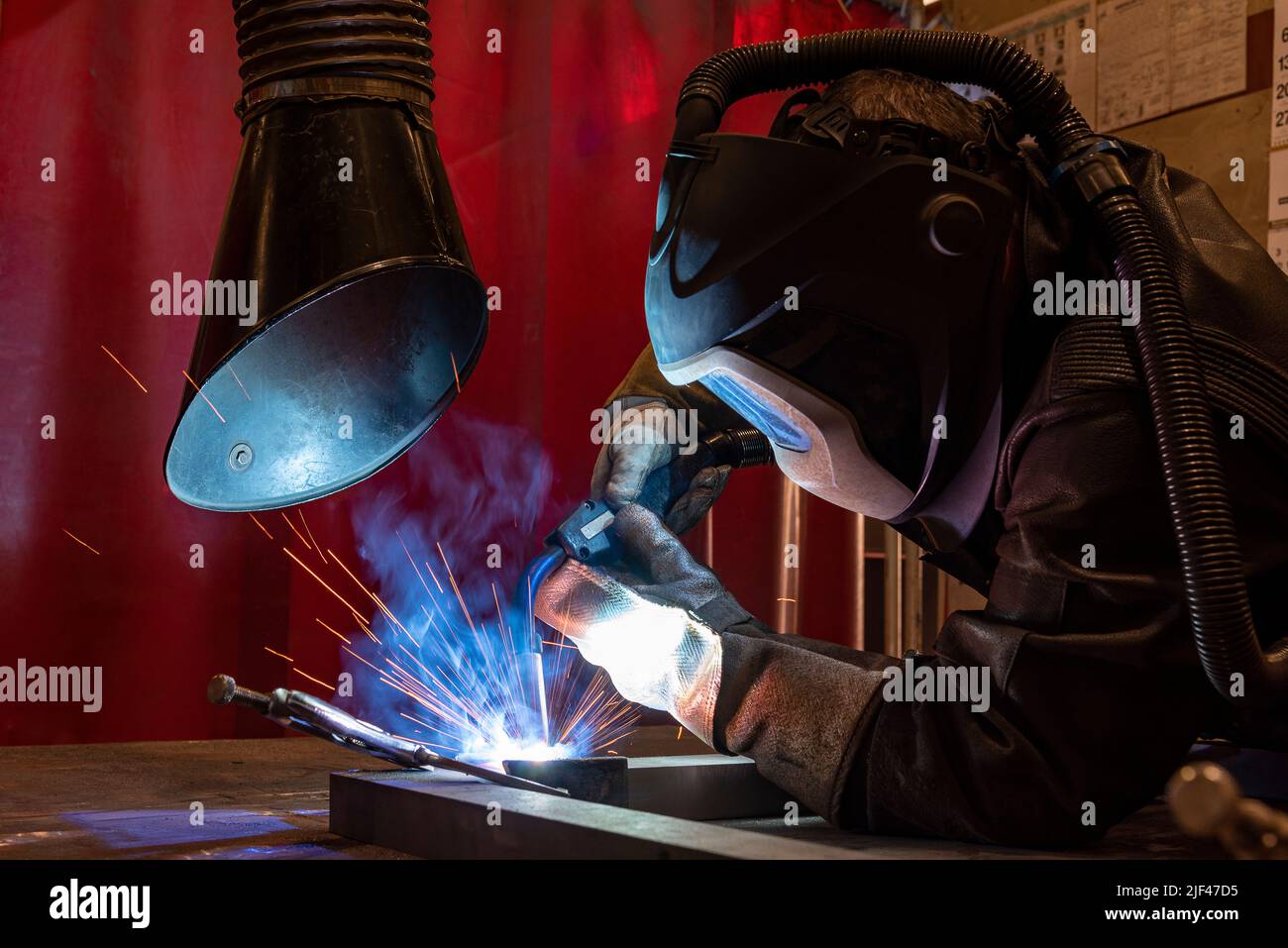 Workers wearing industrial uniforms and Welded Iron Mask at Steel ...