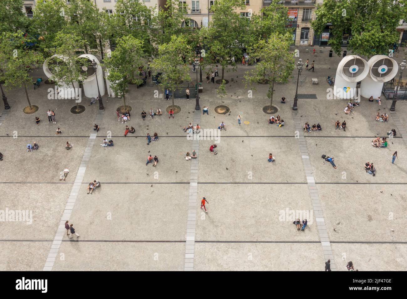 Tourists sitting on the square in front of Centre Georges Pompidou ...