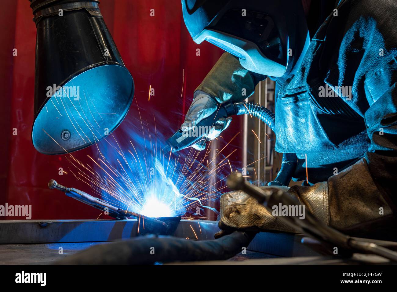 Workers wearing industrial uniforms and Welded Iron Mask at Steel ...