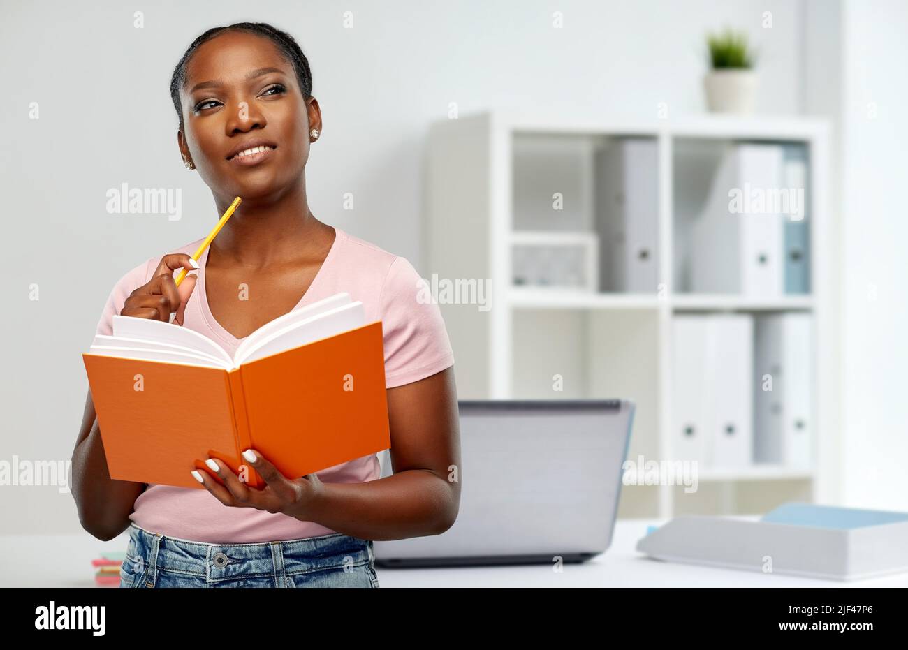 african american woman with notebook at office Stock Photo - Alamy