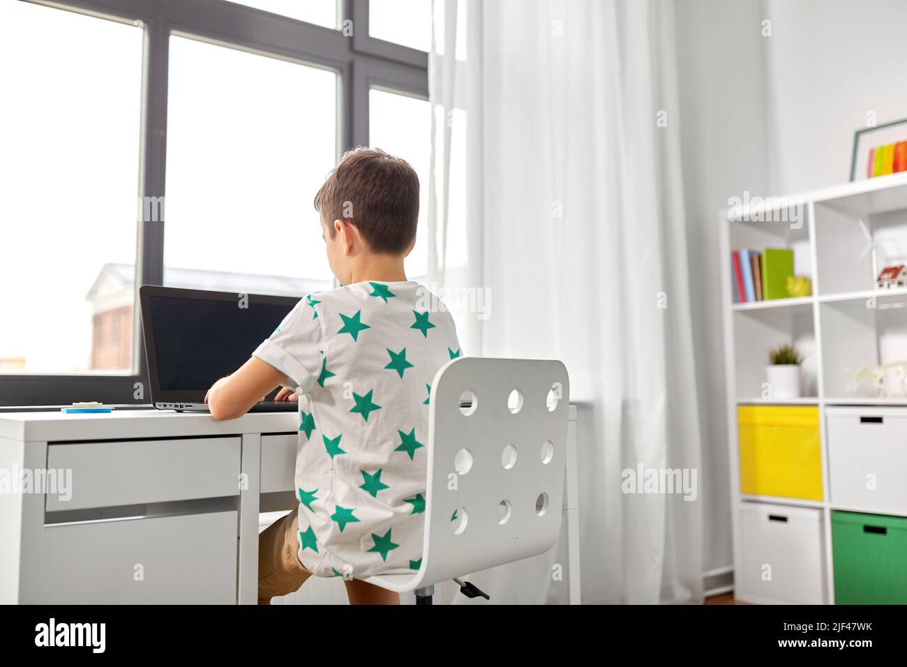 student boy typing on laptop computer at home Stock Photo - Alamy