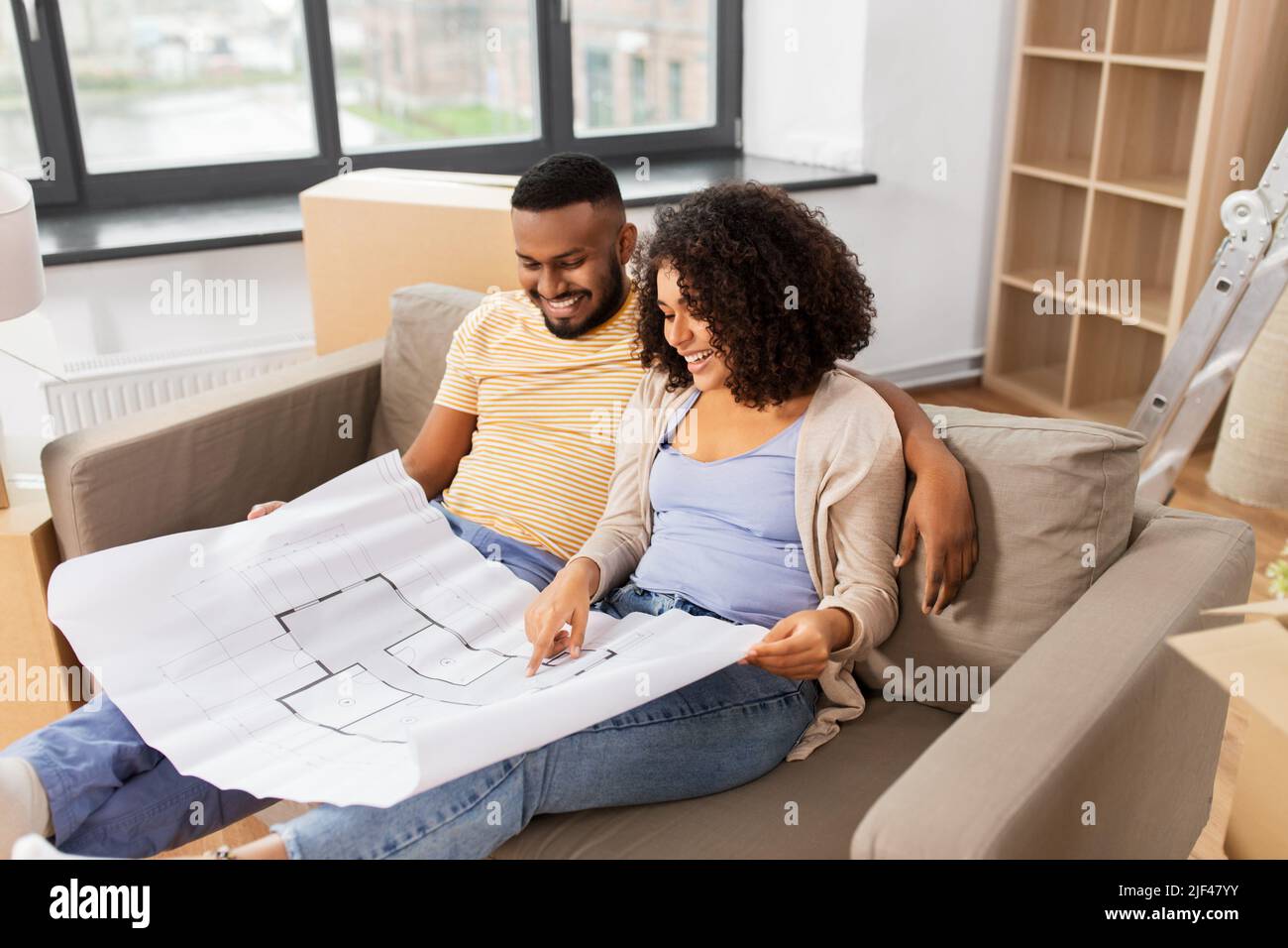 couple with boxes and blueprint moving to new home Stock Photo - Alamy