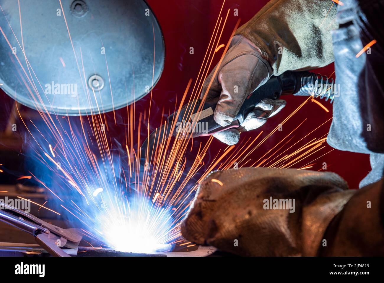 Workers wearing industrial uniforms and Welded Iron Mask at Steel ...