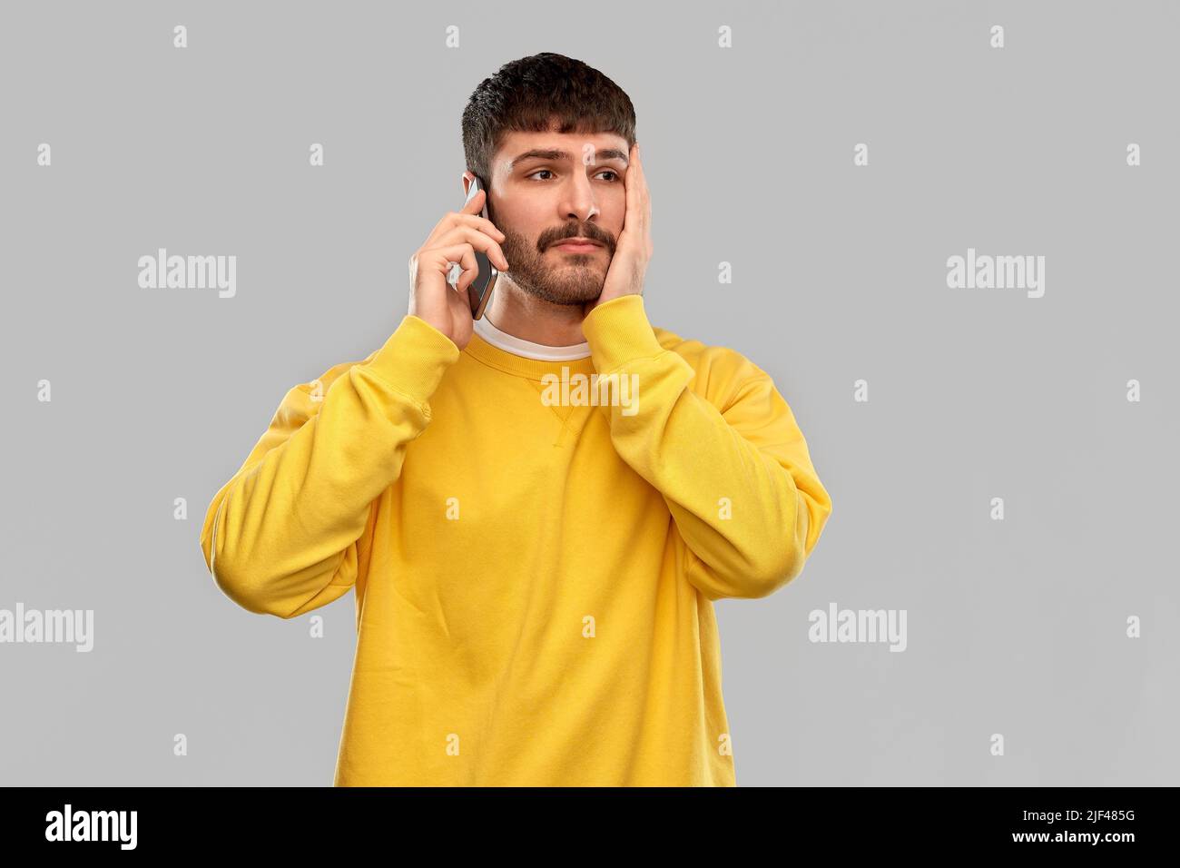 sad young man calling on smartphone Stock Photo - Alamy