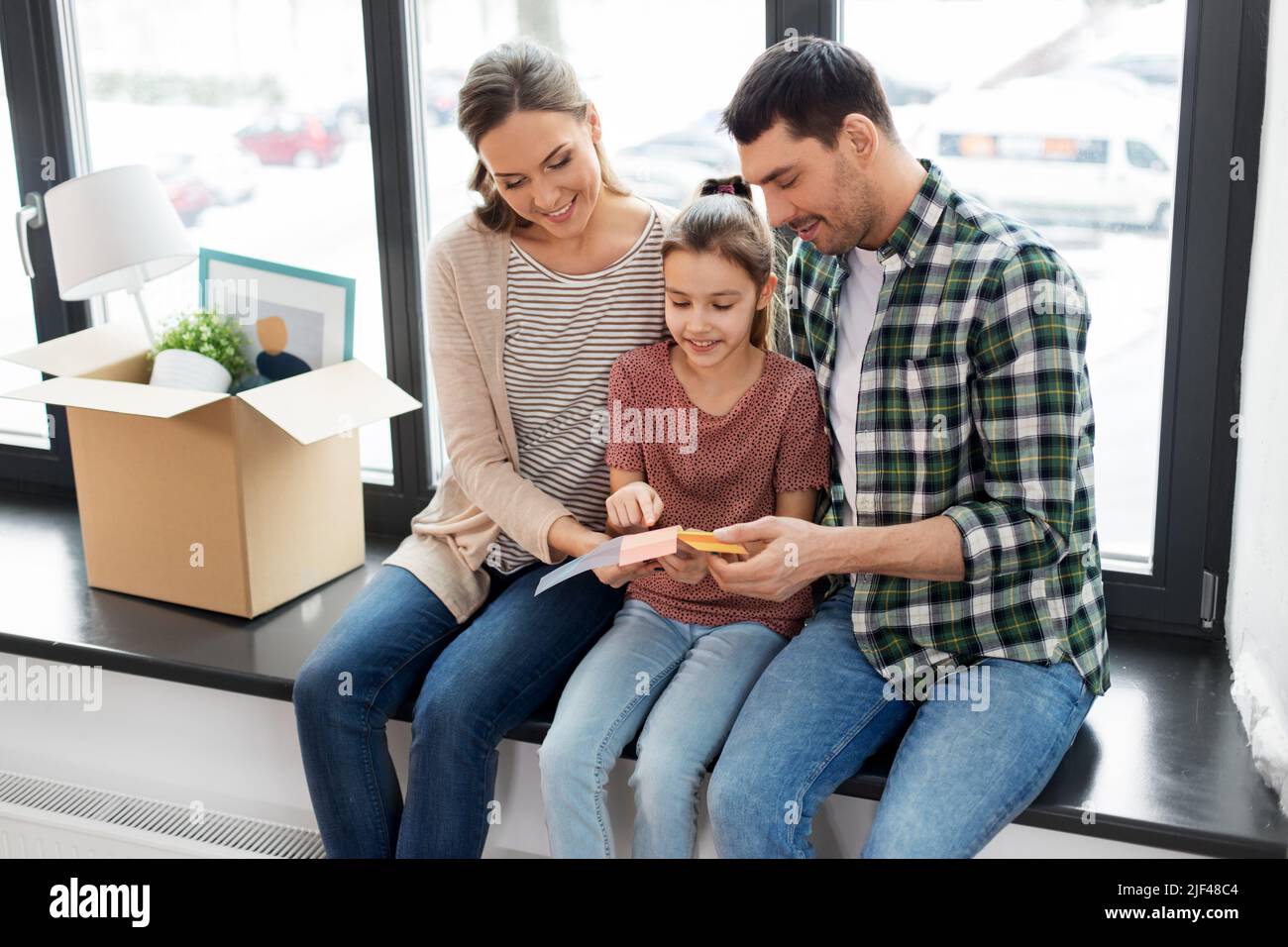 happy family with color palette moving to new home Stock Photo - Alamy