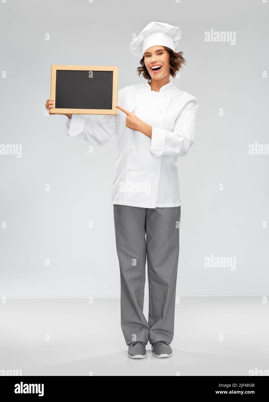 smiling female chef holding black chalkboard Stock Photo - Alamy