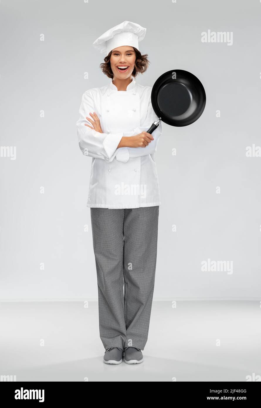 smiling female chef in toque with frying pan Stock Photo - Alamy