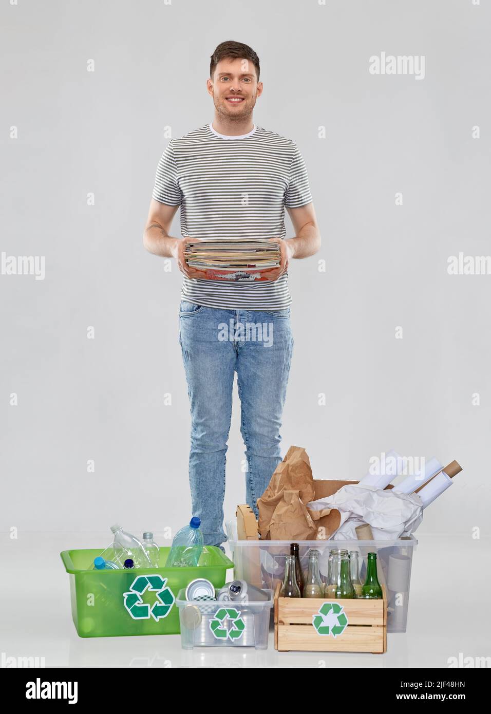 smiling man sorting paper, metal and plastic waste Stock Photo - Alamy