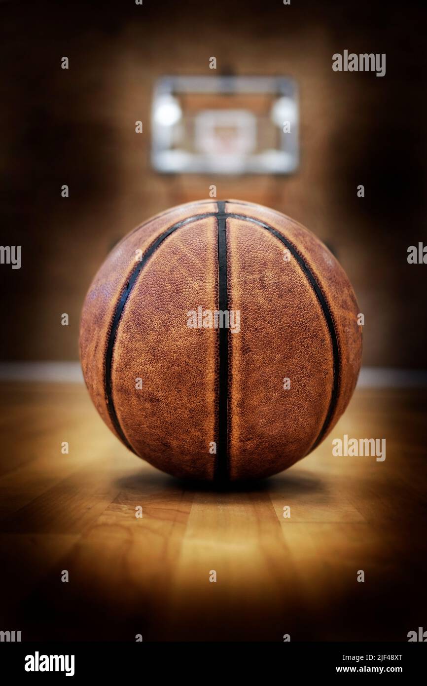 Basketball court with ball hoops rims hardwood floor and lights for ...