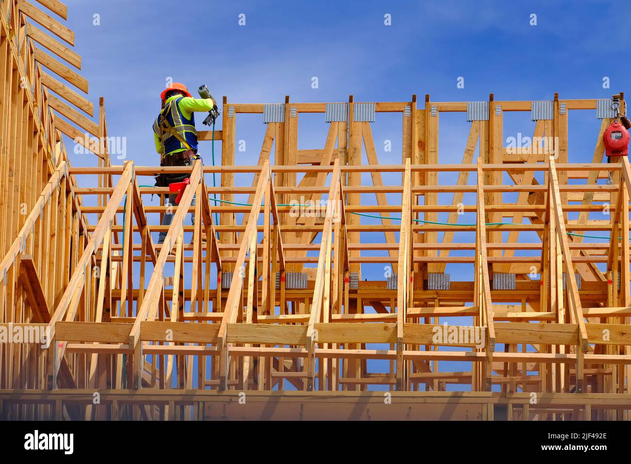 Construction workers working on new home or restidential building with ...