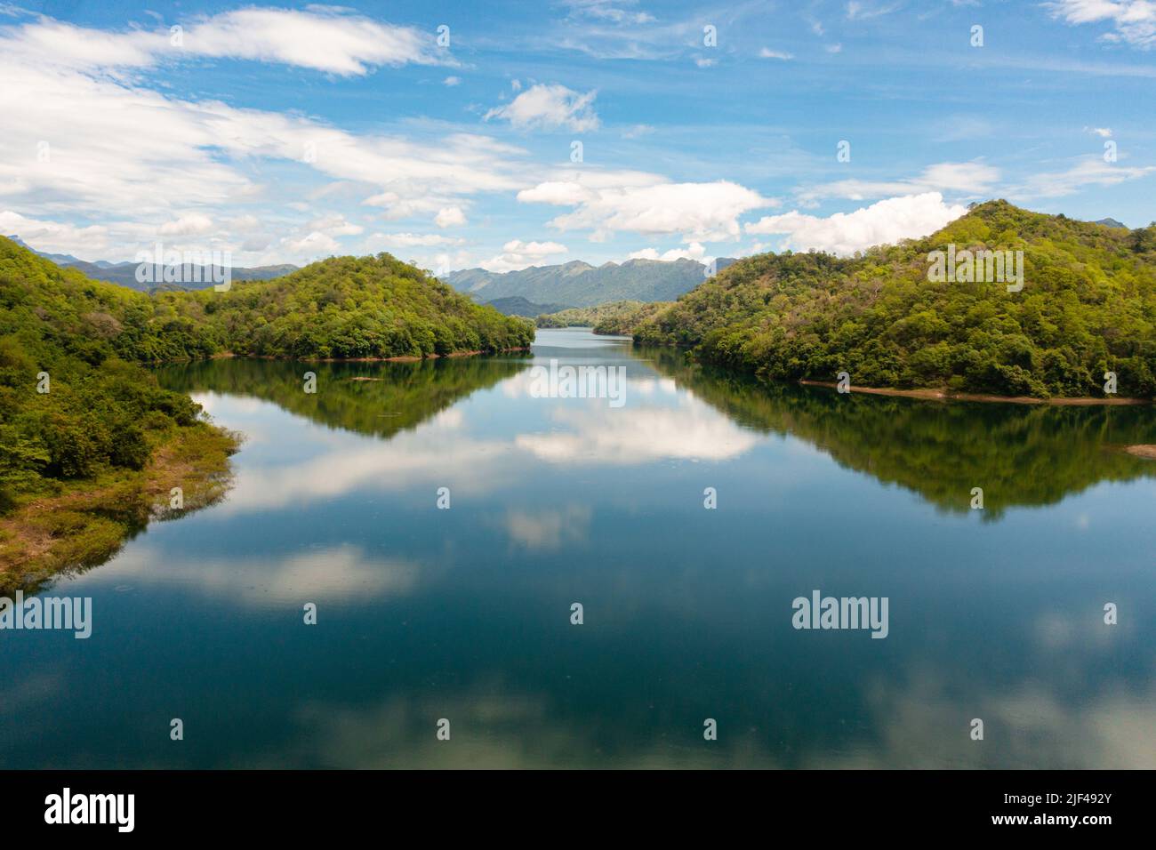 Aerial view of river among mountains and hills with a reflecting blue ...