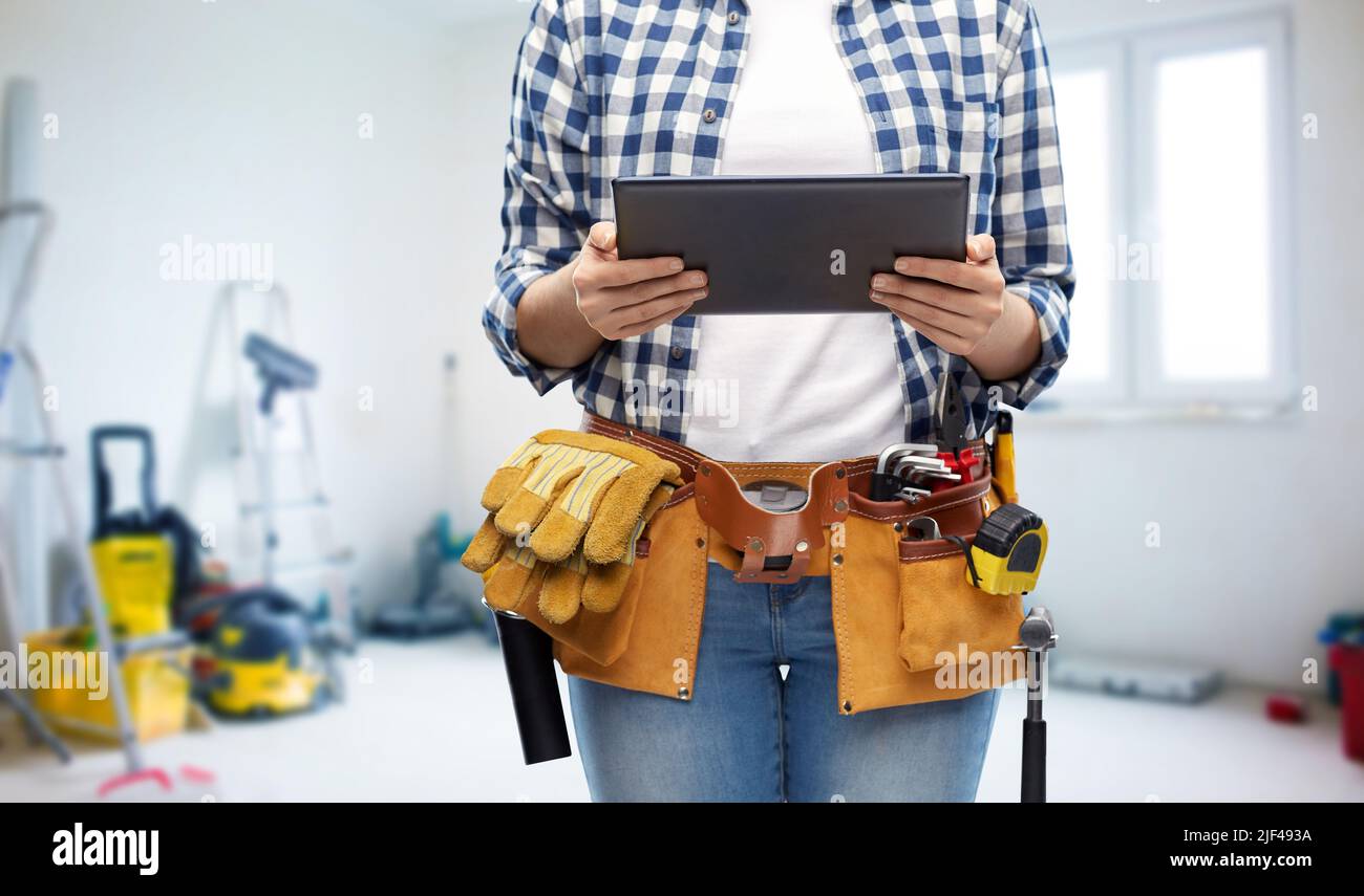 woman or builder with tablet pc and working tools Stock Photo - Alamy
