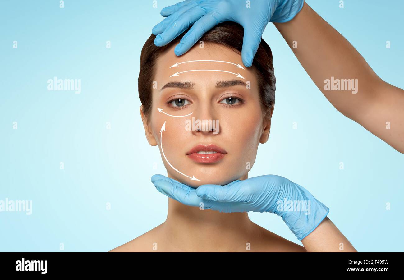 beautiful young woman face and hand in gloves Stock Photo - Alamy
