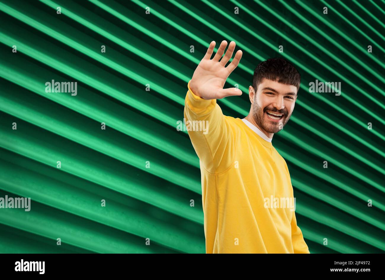 Young man waving hand hi-res stock photography and images - Alamy