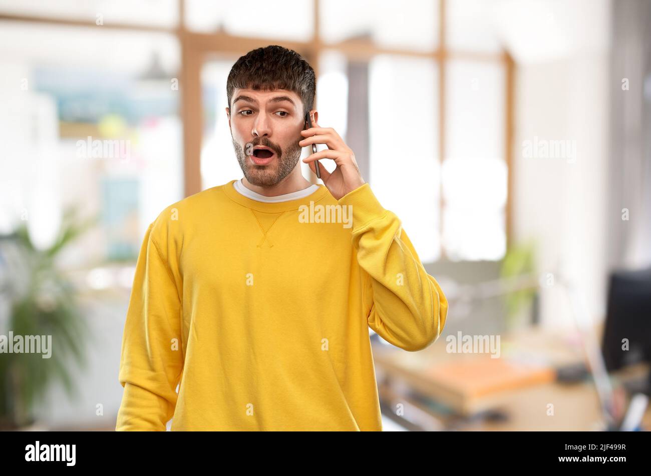 shocked young man calling on smartphone Stock Photo - Alamy