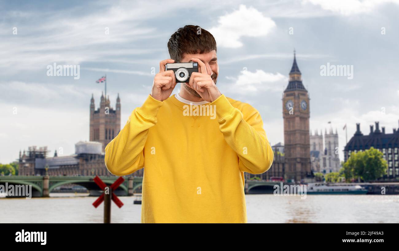 young man with vintage film camera over london Stock Photo - Alamy