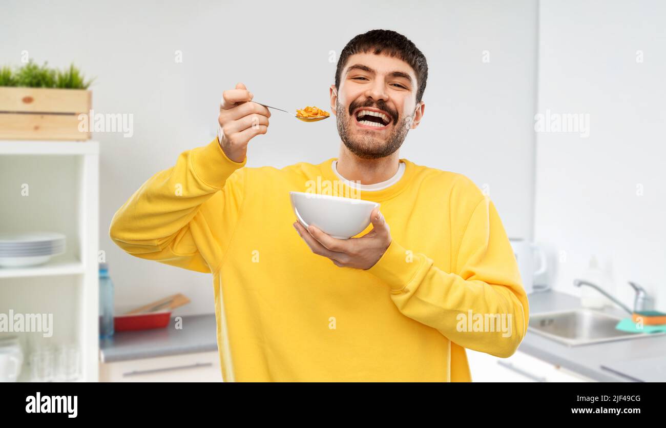 Man, happy, eating with spoon hi-res stock photography and images - Alamy