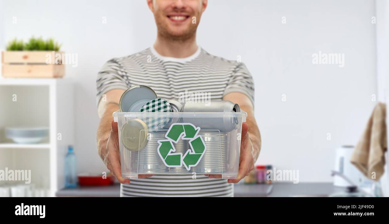 smiling young man sorting metallic waste Stock Photo - Alamy