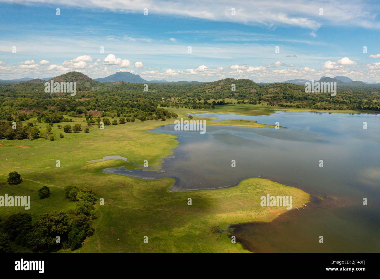 Aerial view of valley with a lake and tropical vegetation against a ...