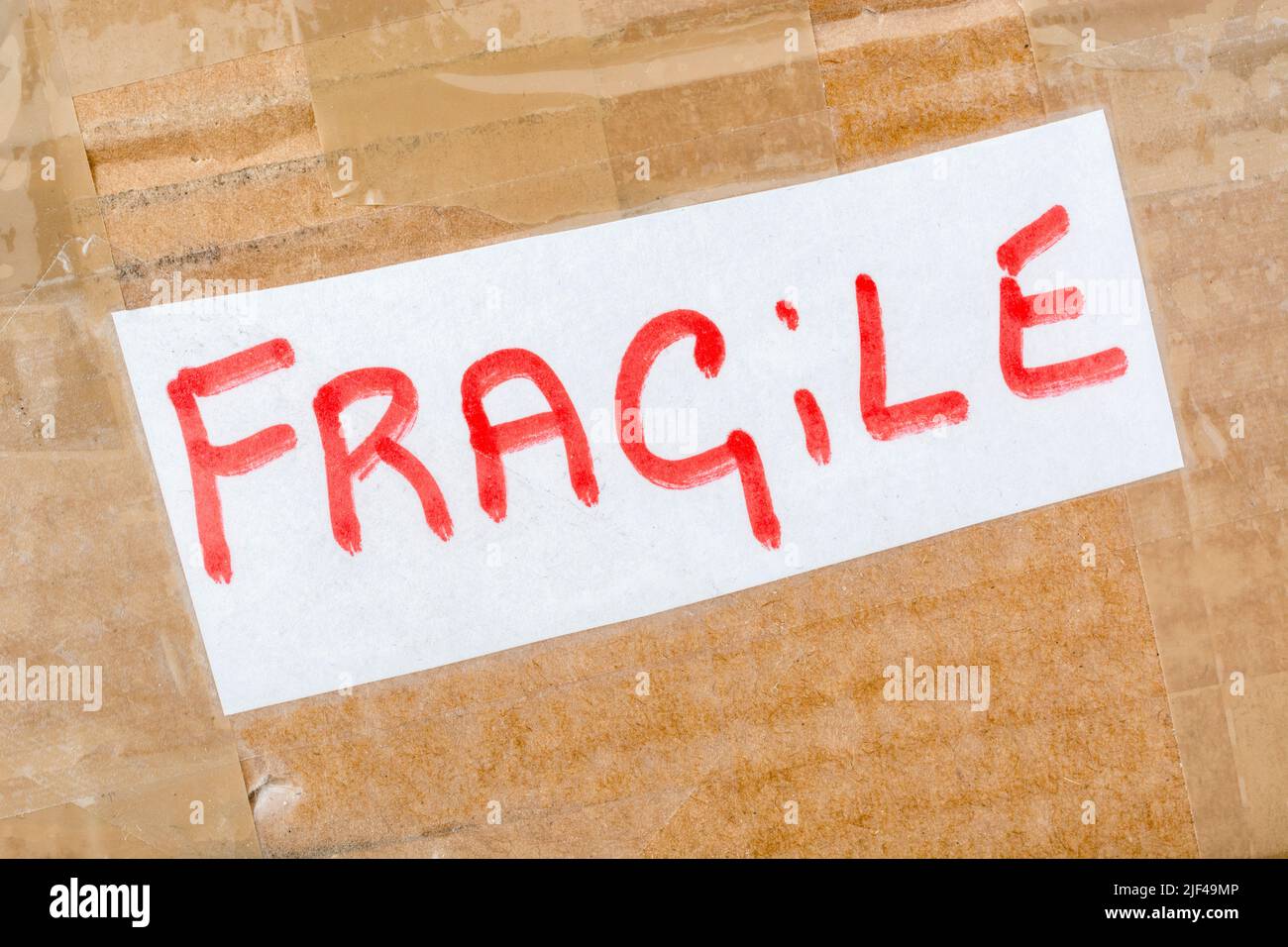 Brown cardboard shipping box with handwritten red on white 'Fragile ...