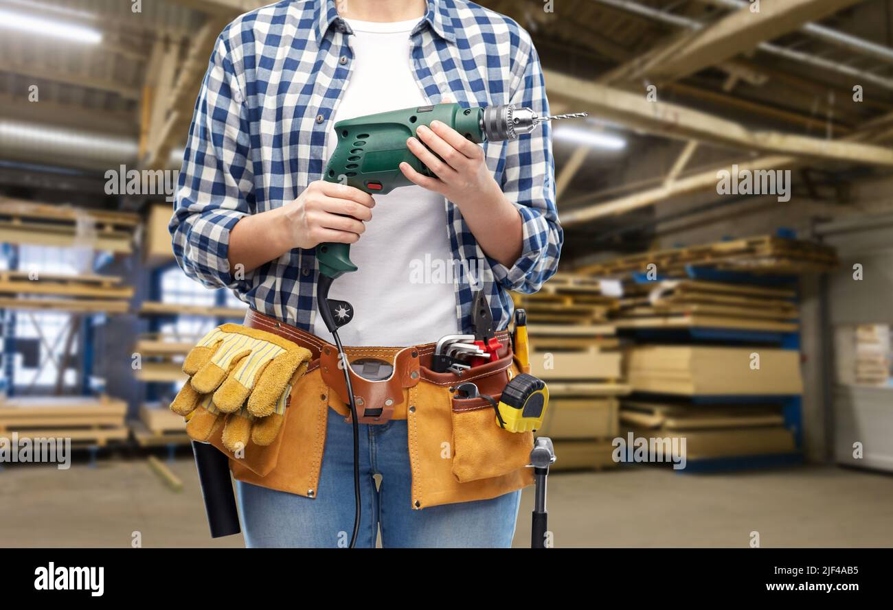woman or worker with drill and work tools Stock Photo - Alamy