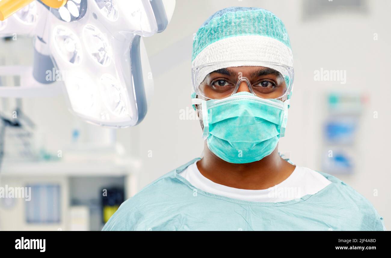 indian male surgeon in mask over operating room Stock Photo - Alamy