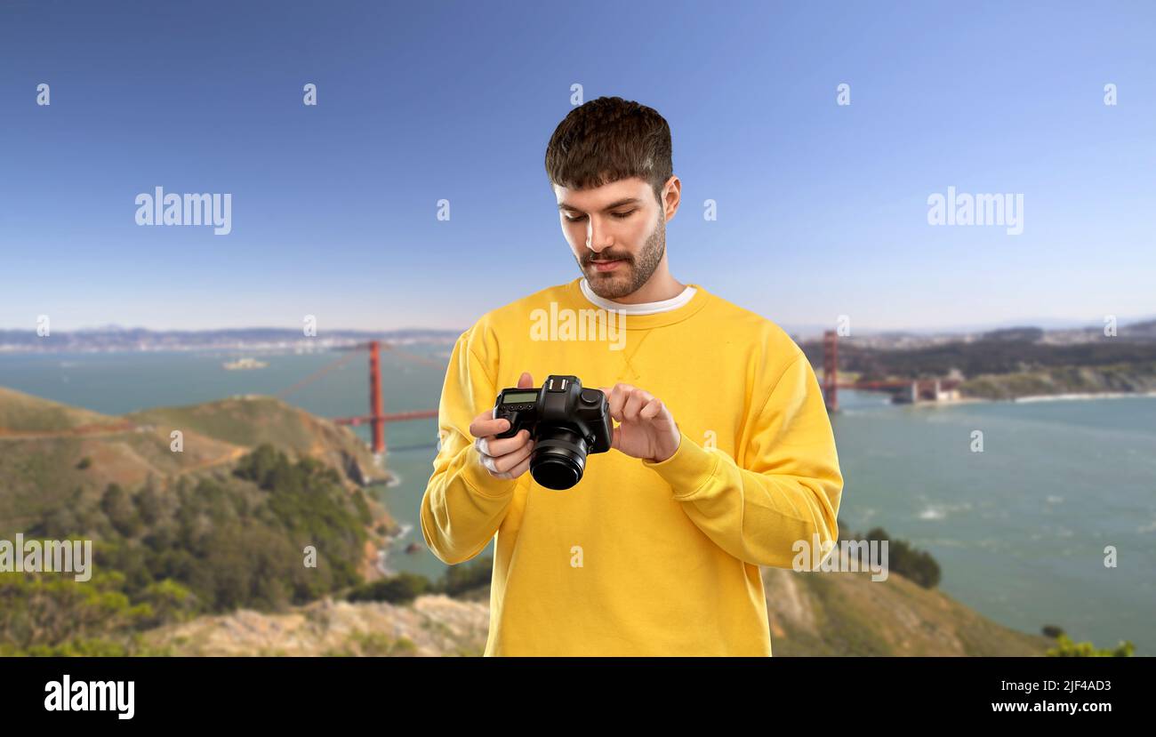 man with camera over golden gate bridge Stock Photo - Alamy