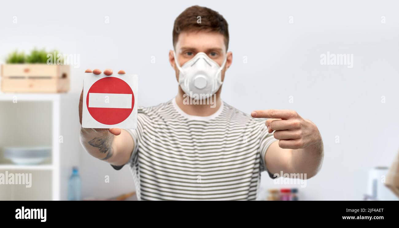 man in respirator mask showing stop sign Stock Photo - Alamy