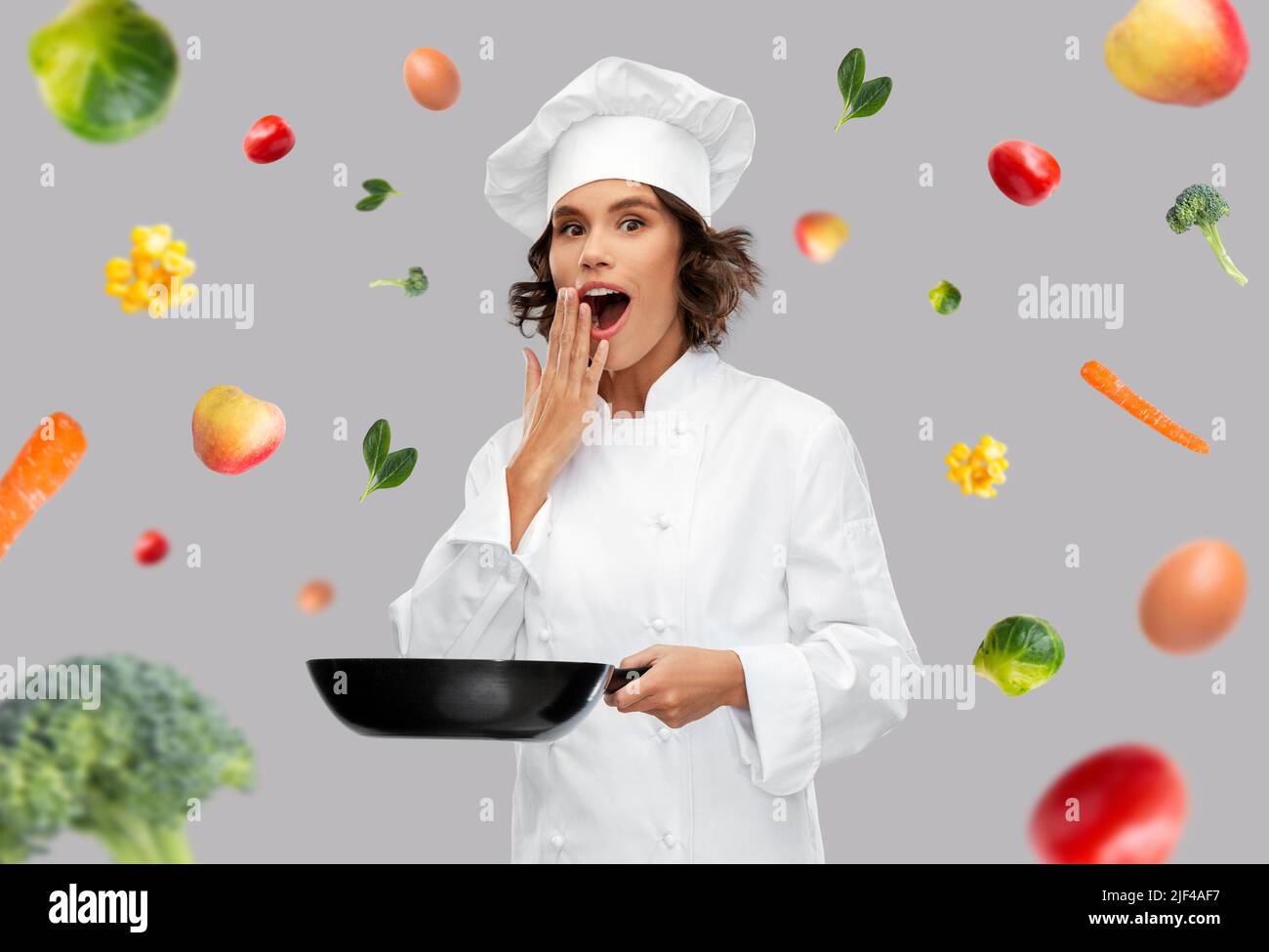 surprised female chef with frying pan over food Stock Photo - Alamy