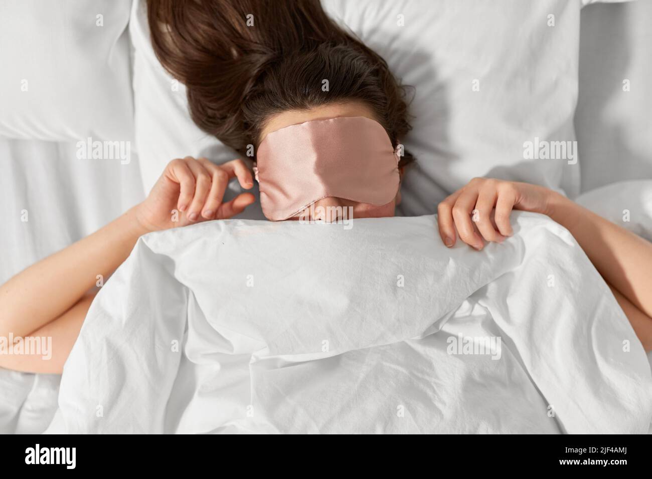 woman with eye sleeping mask in bed under blanket Stock Photo - Alamy
