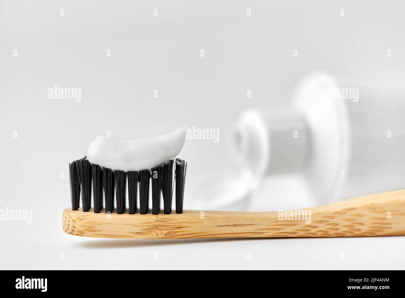 natural wooden toothbrush with toothpaste on it Stock Photo - Alamy