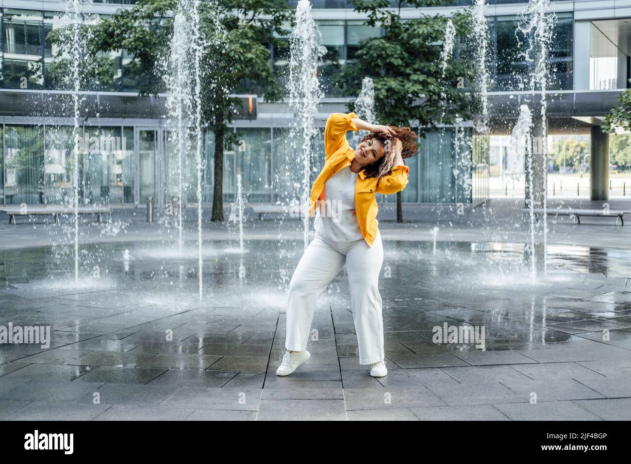 Confident Plus size curvy happy young woman dancing street fountains ...