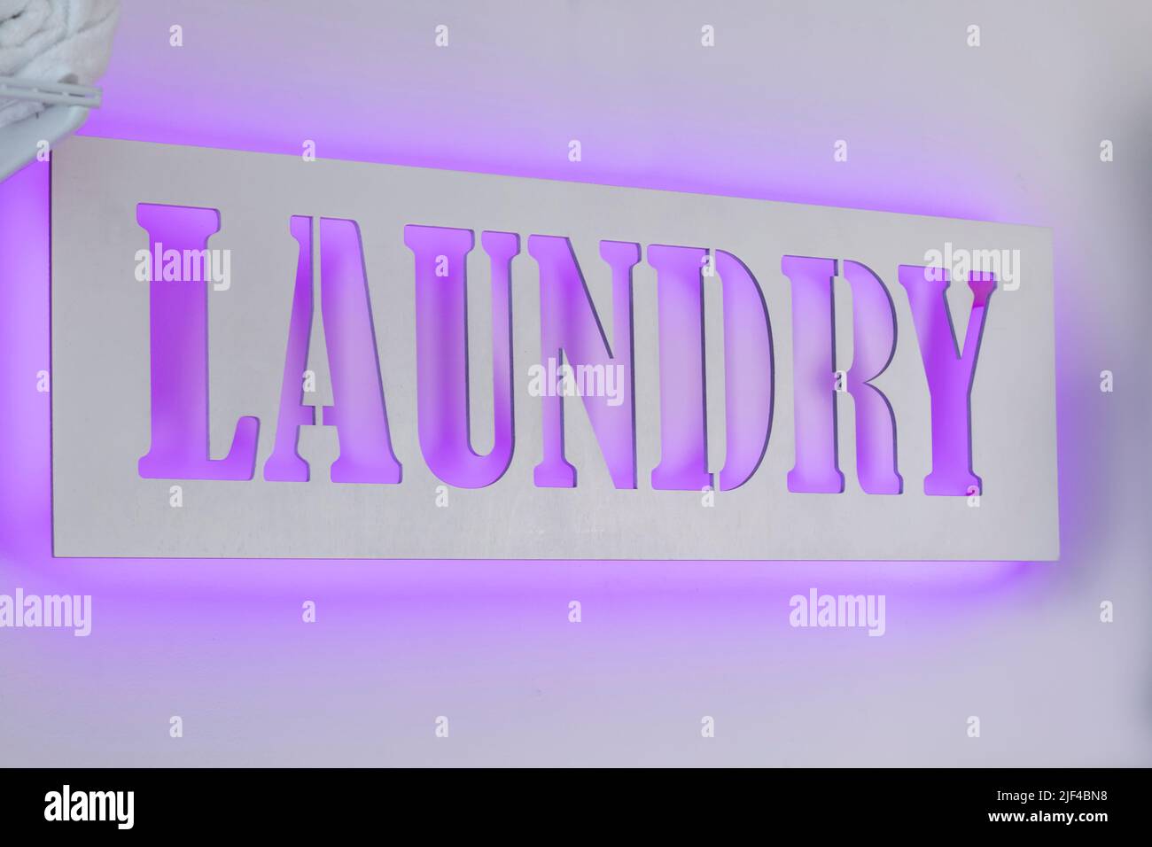 Glowing neon laundry sign on a white background. Illuminated signboard ...