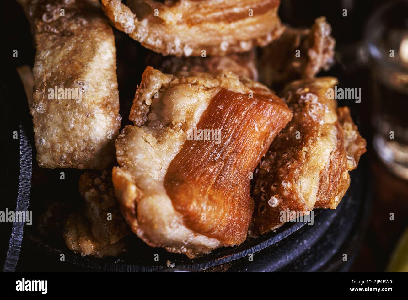 Brazilian crackling, an appetizer made by frying bacon, a layer of ...