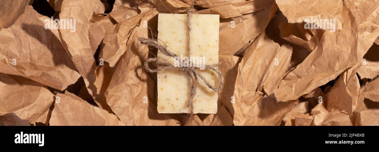 Natural handmade organic soap on multiple pieces of torn brown craft ...