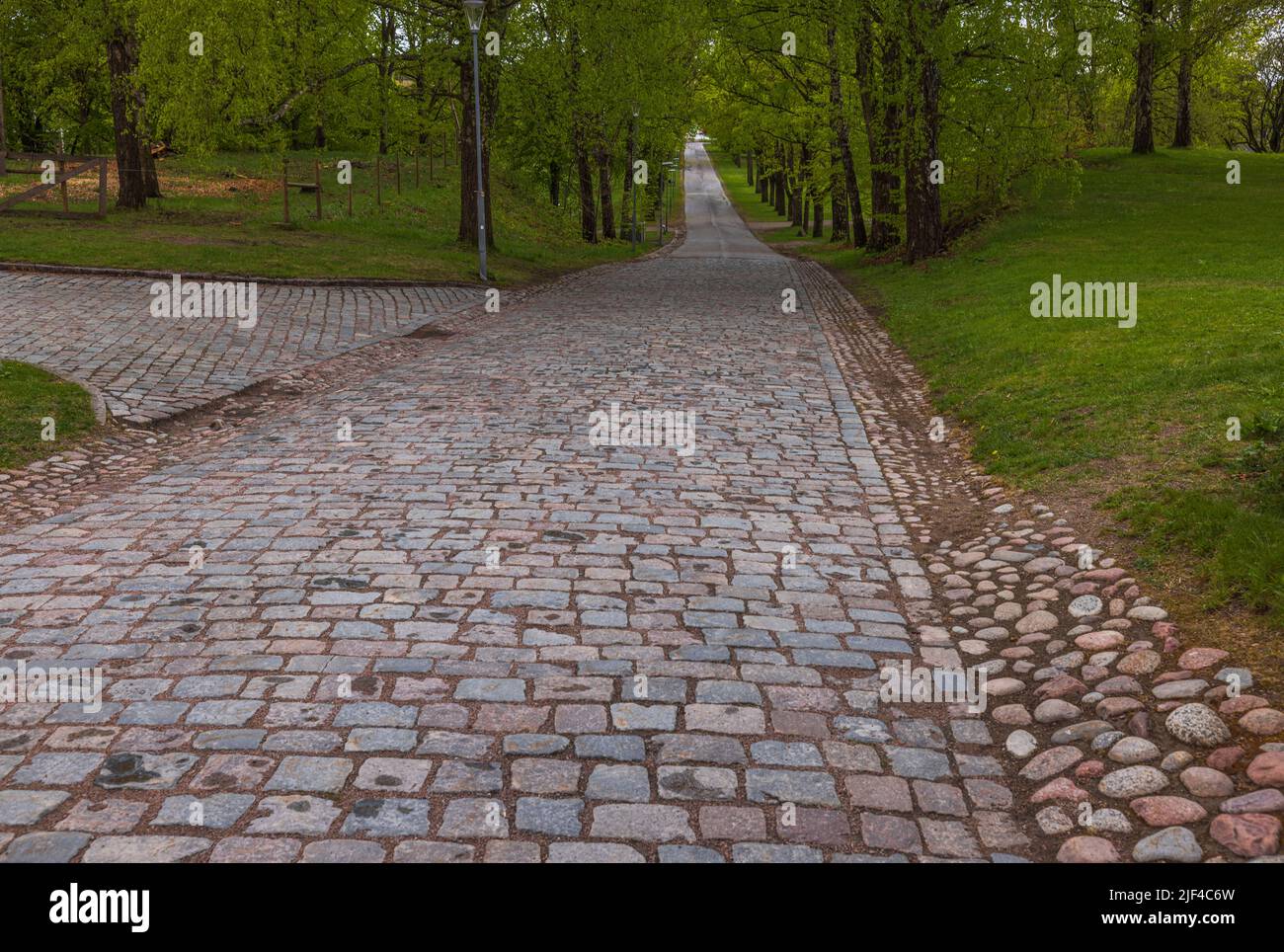 Beautiful view of park with old cobblestone pavement stone walkway ...